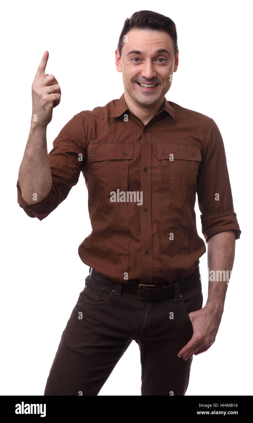 Handsome smiling man pointing upwards. Isolated on white background ...