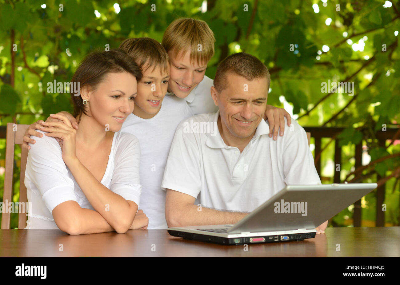 family using laptop Stock Photo - Alamy