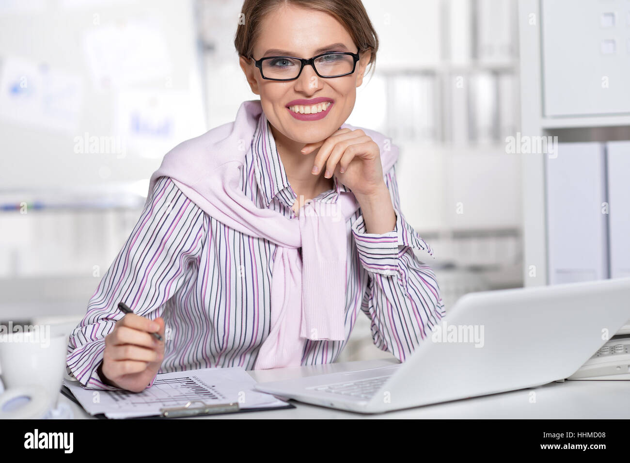 young woman working at office Stock Photo - Alamy