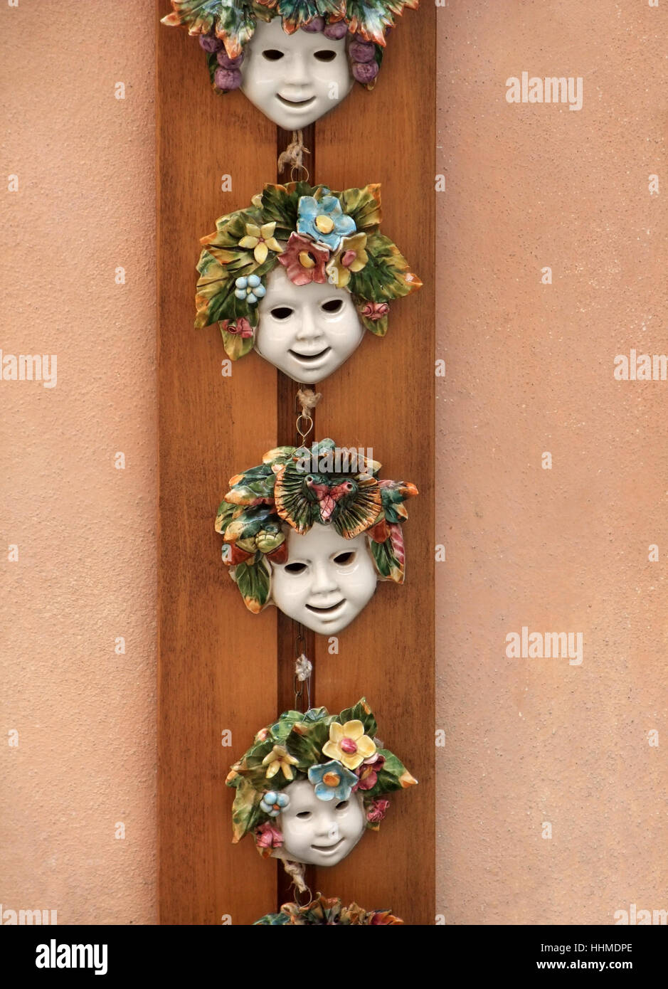 some colorful deco faces seen in Italy Stock Photo - Alamy