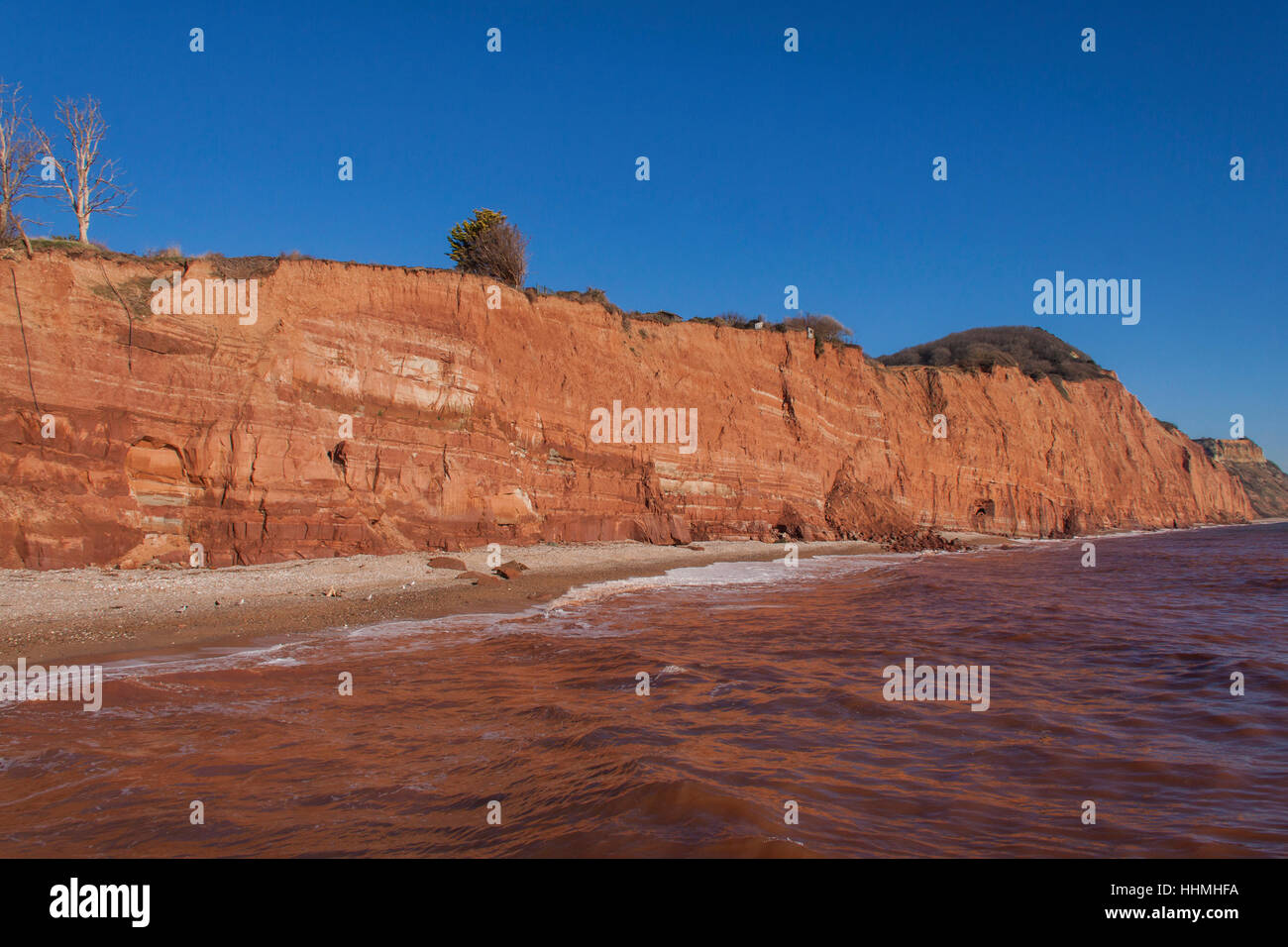 Red sandstone cliffs at Sidmouth, Devon, falling into the sea due to ...