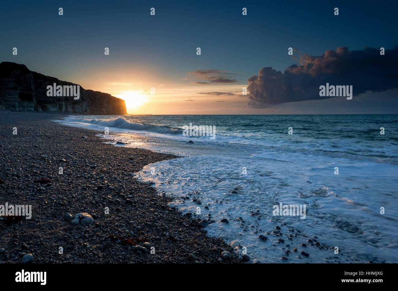 sunset over ocean coast with cliffs, Etretat, France Stock Photo - Alamy