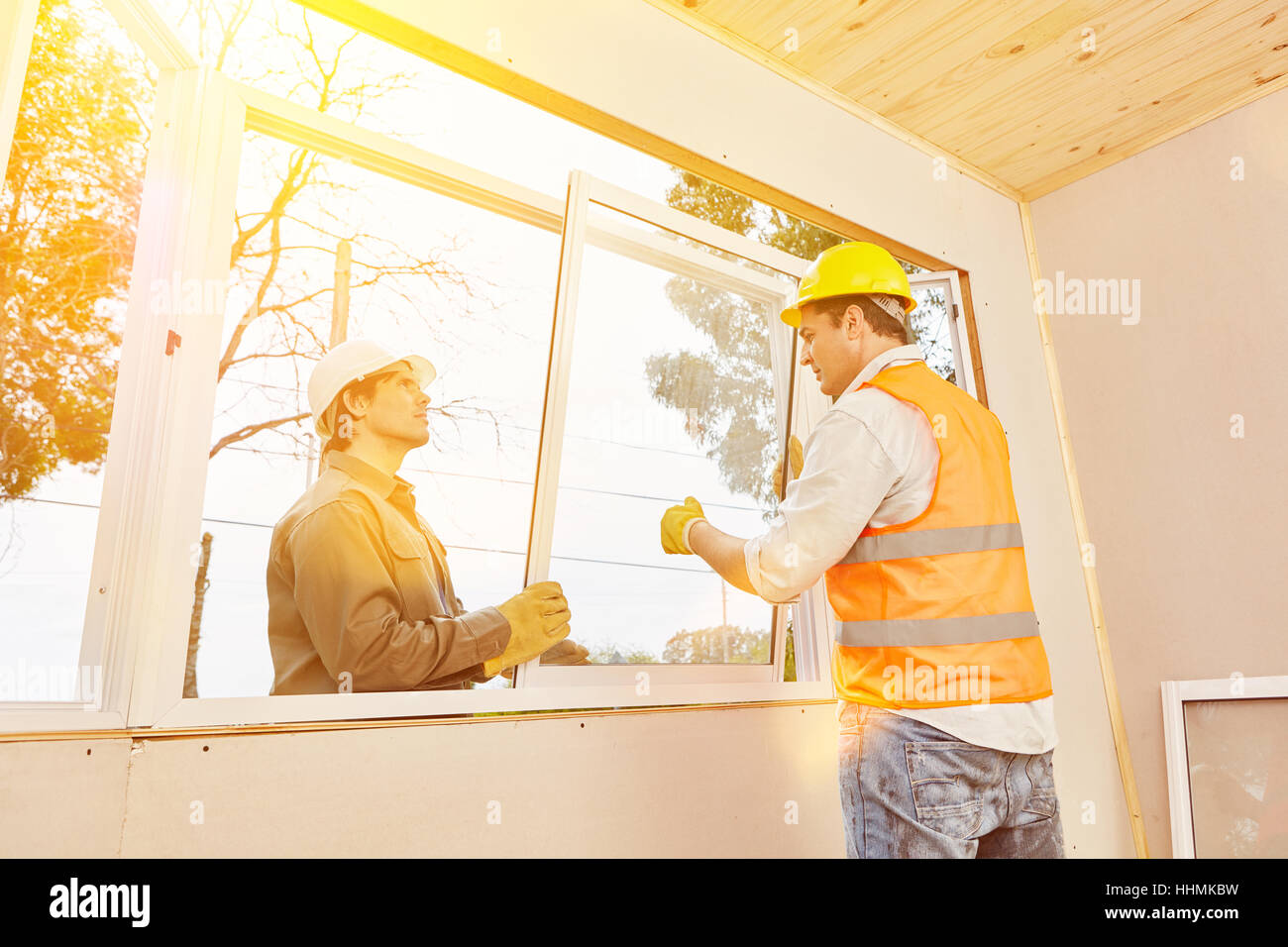 Teamwork between artisan and craftsman installing window Stock Photo ...
