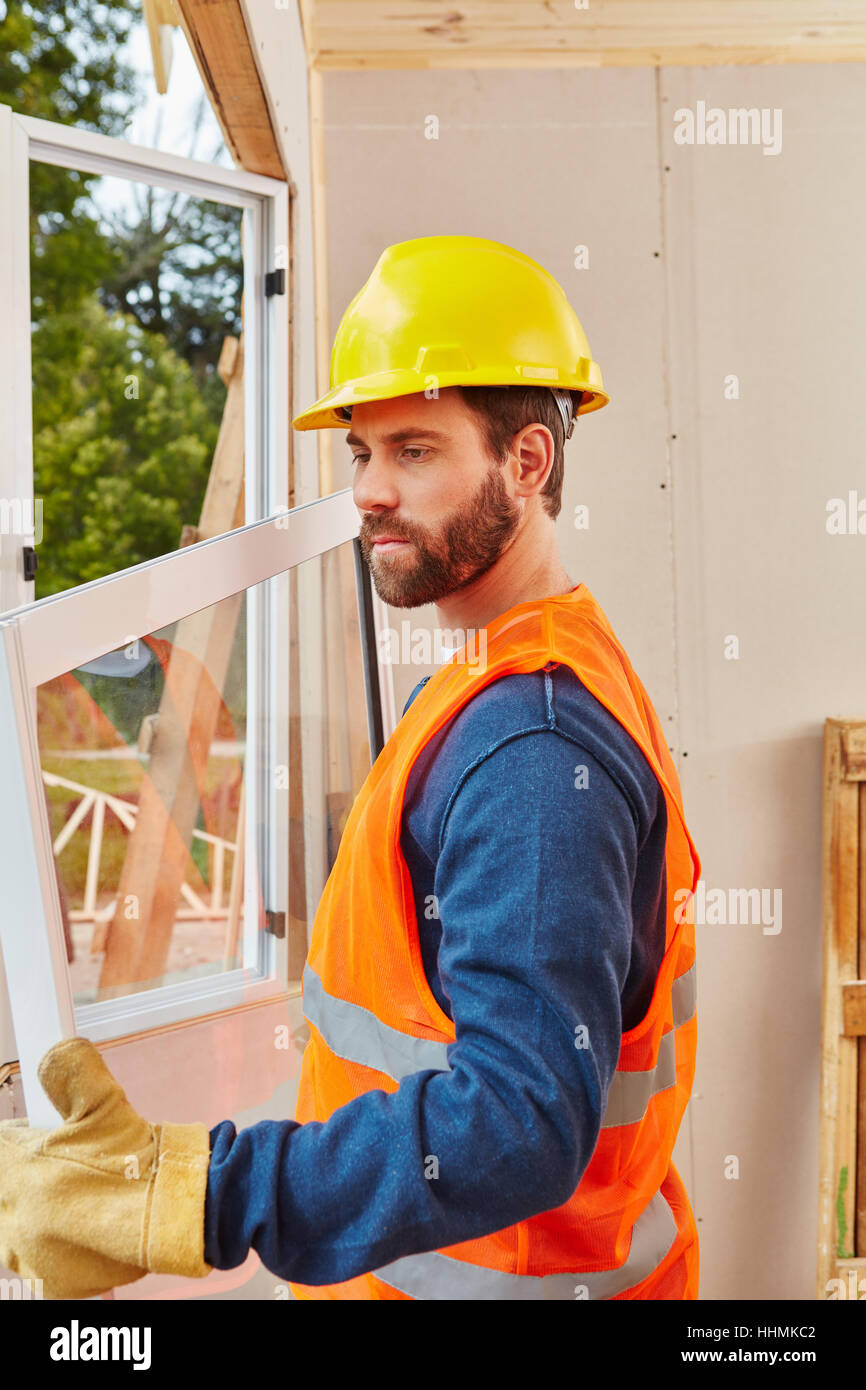 Window builder working on mount of new installation Stock Photo - Alamy