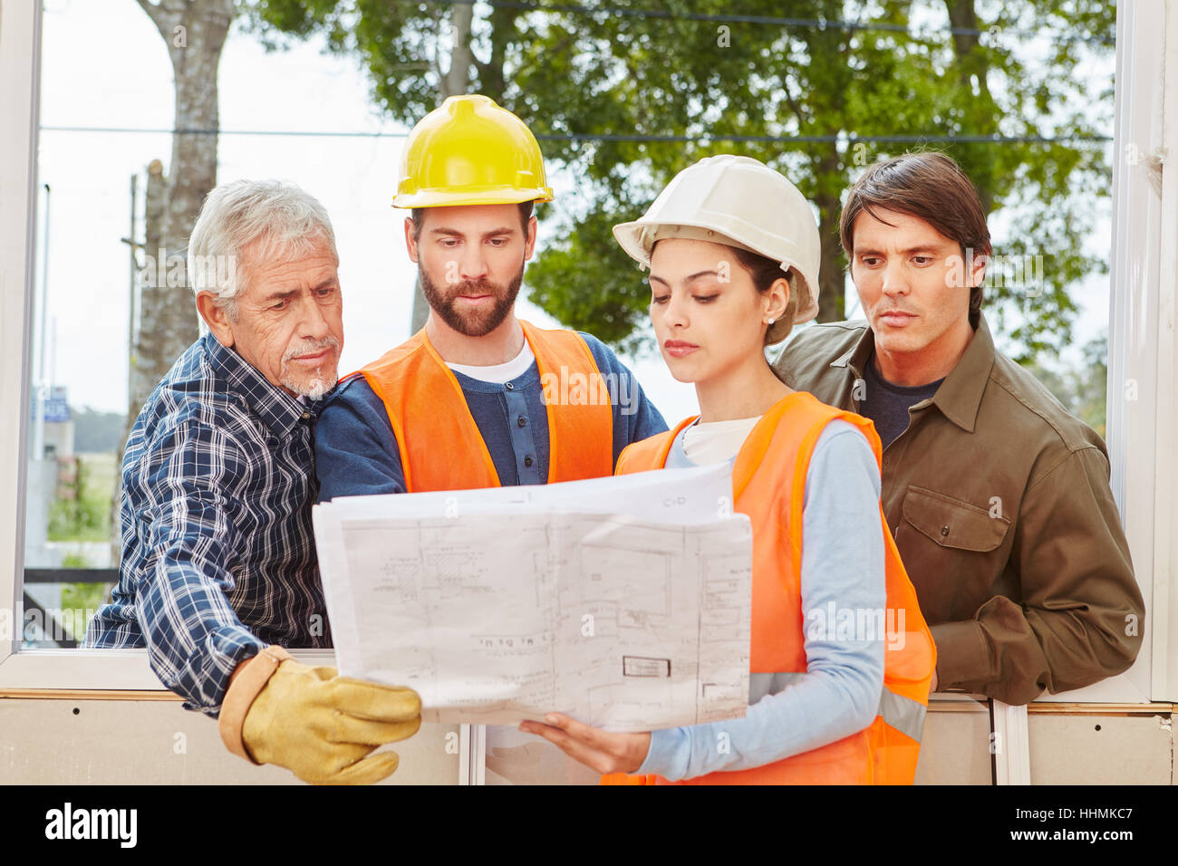 Building construction team planning new house with floorplan Stock ...