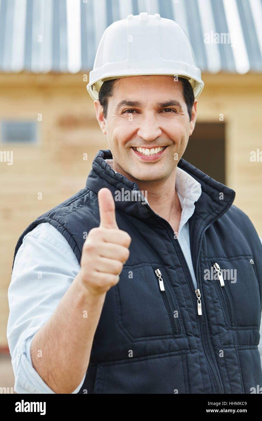 Successful craftsman or foreman holding thumbs up Stock Photo - Alamy