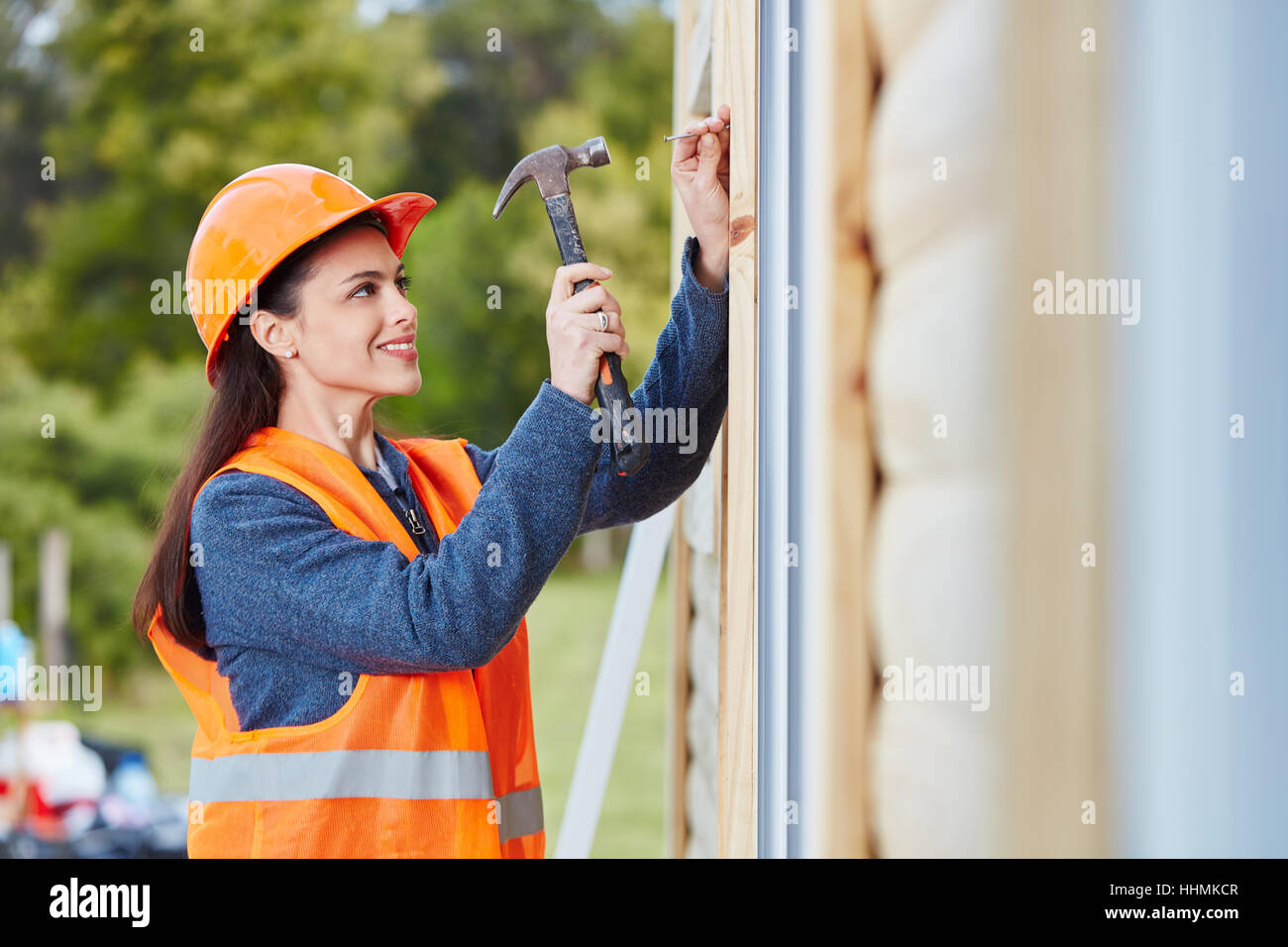 Woman as carpenter apprentice building new house Stock Photo - Alamy