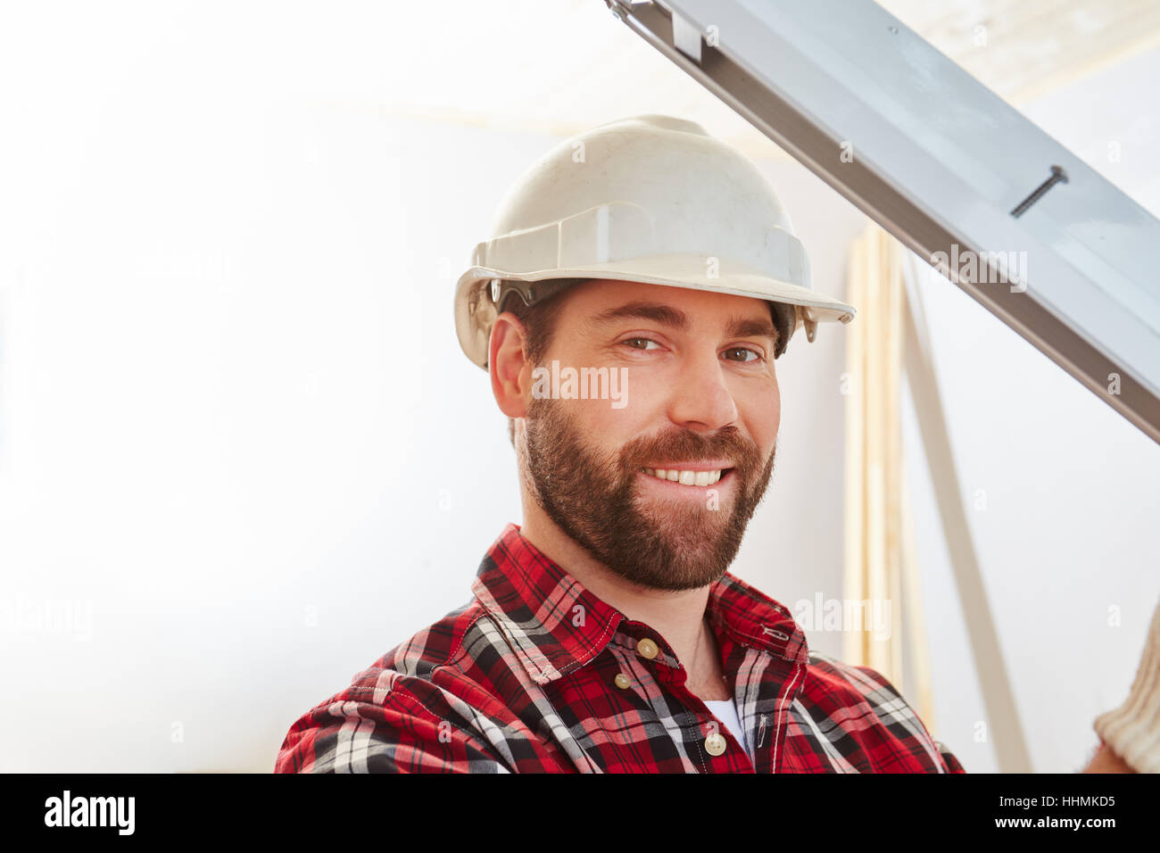 Skilled window builder mechanic fitting new window at construction site ...