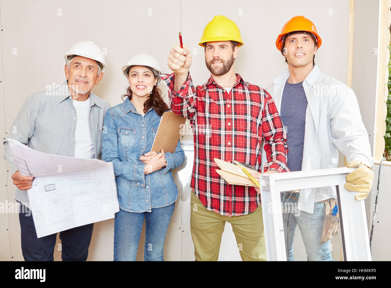 Group of craftsmen as team working and planning building construction ...
