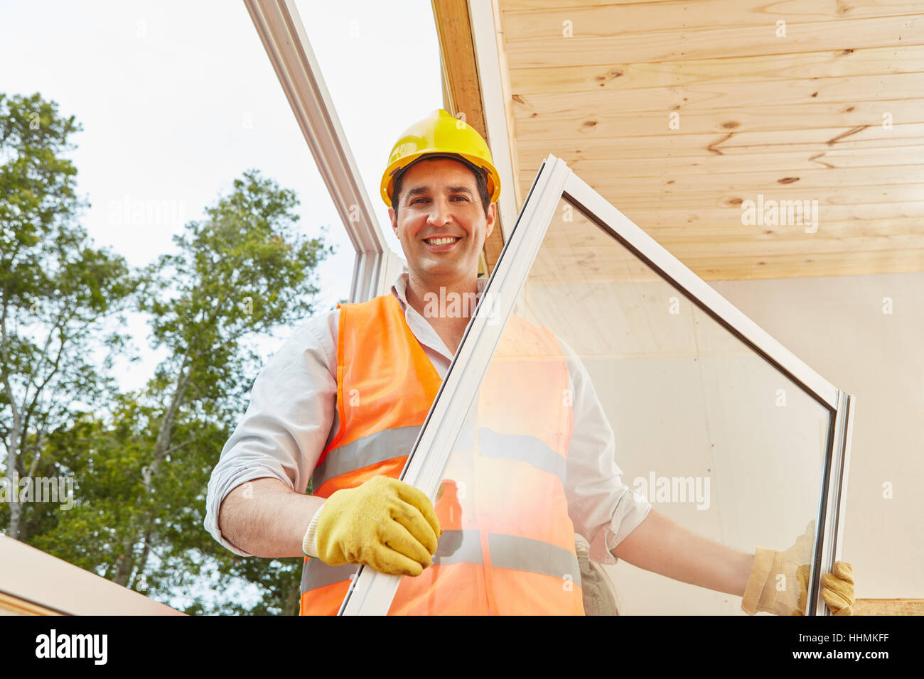 Competent window fitter working in woodhouse installation process Stock ...