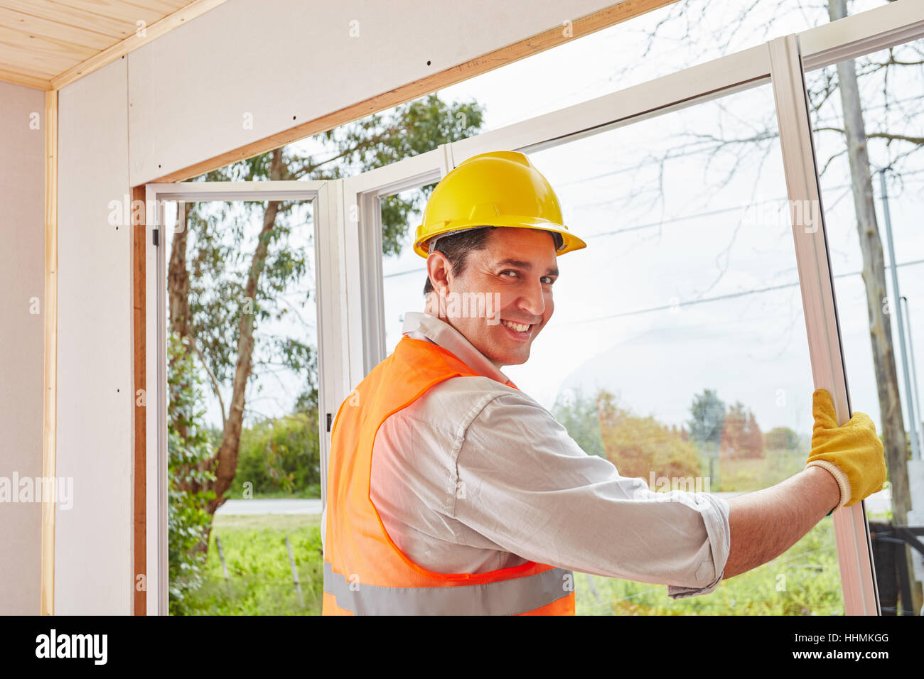 Man as skilled window fitter assembles new window Stock Photo - Alamy