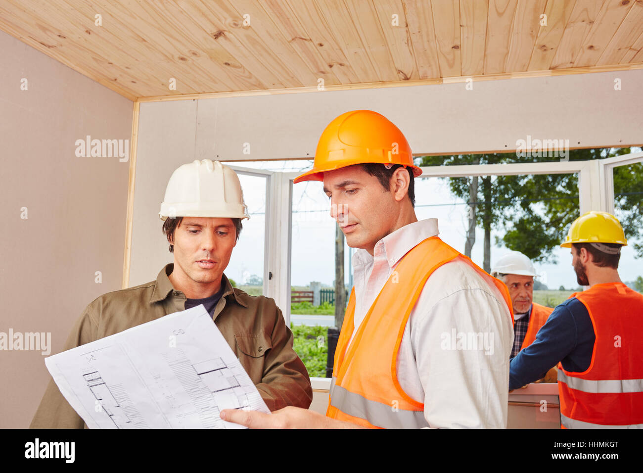 Architect and craftsmen working using floorplan for planning Stock ...