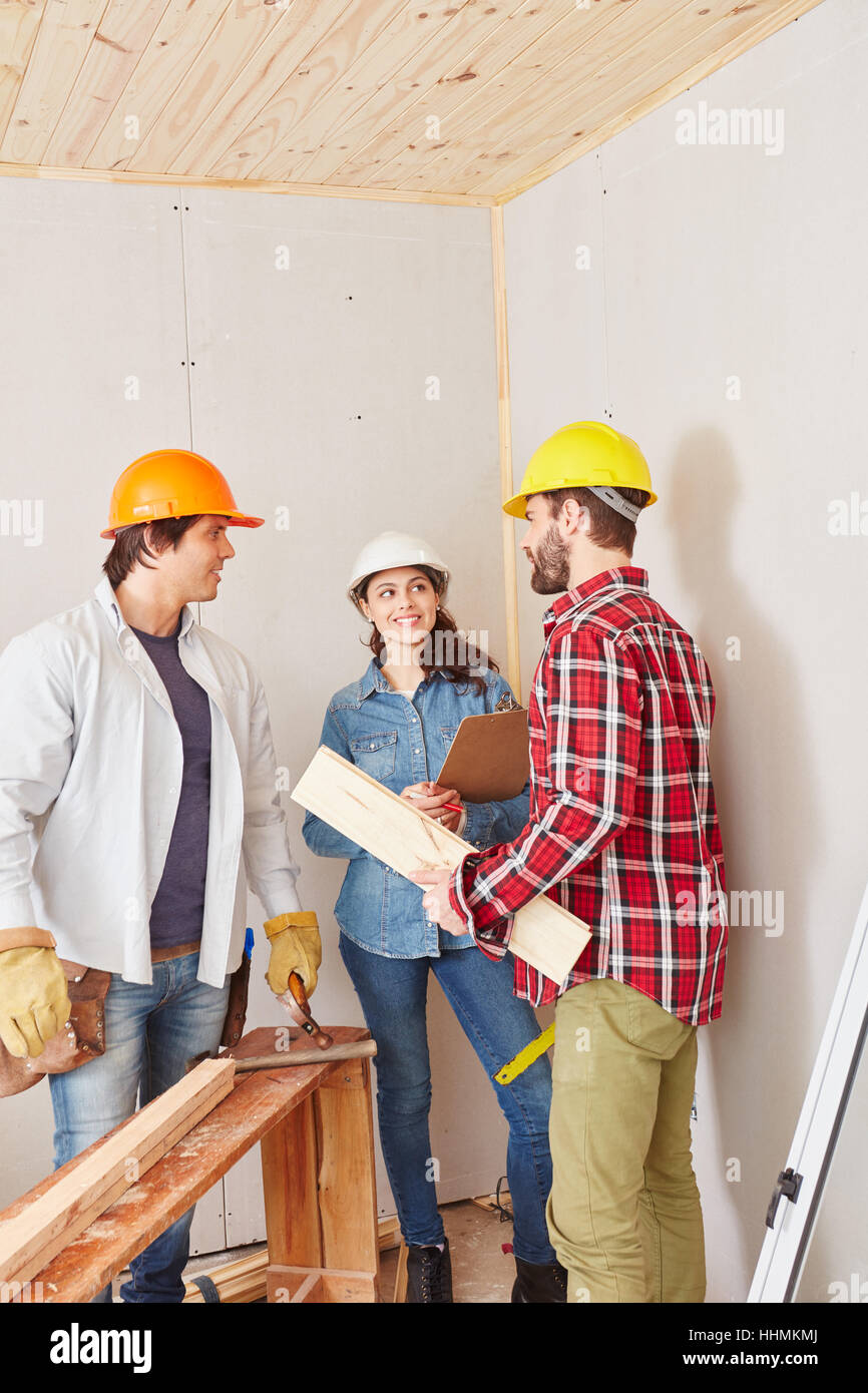 Craftsmen in meeting with carpenter as a team Stock Photo - Alamy