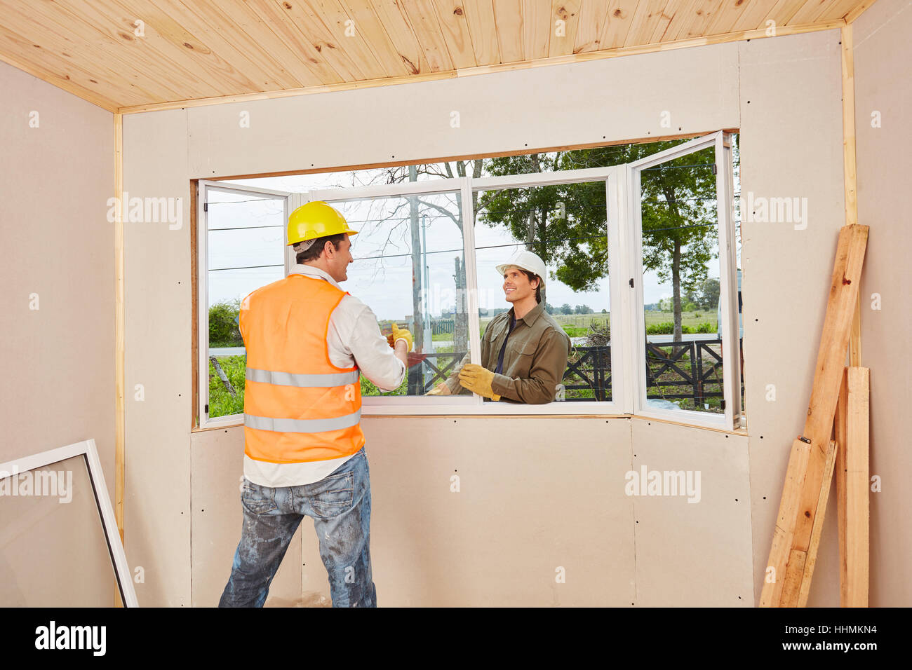 Window fitters installing new window at construction site Stock Photo ...
