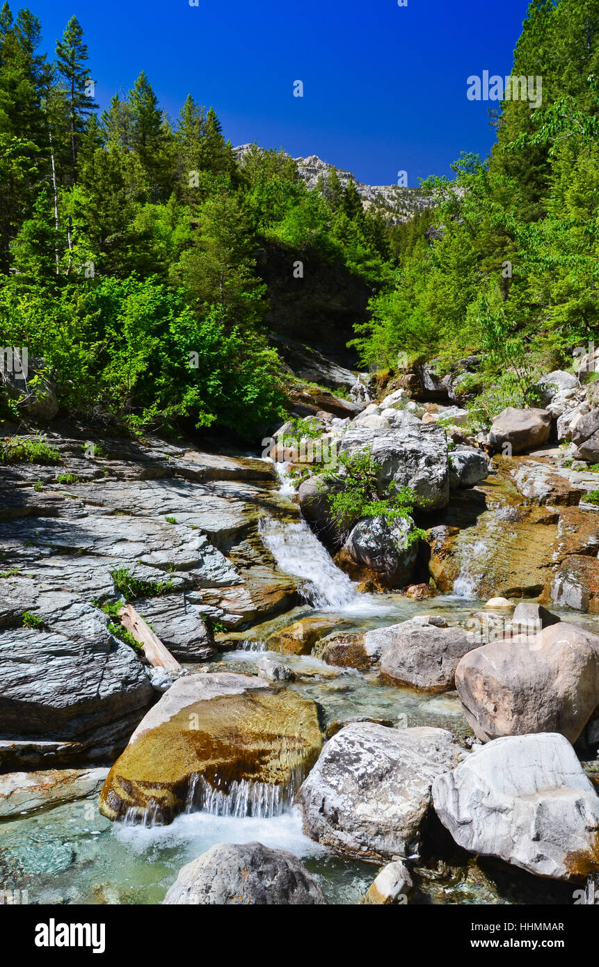 A small water cascade through rocky terrain Stock Photo - Alamy