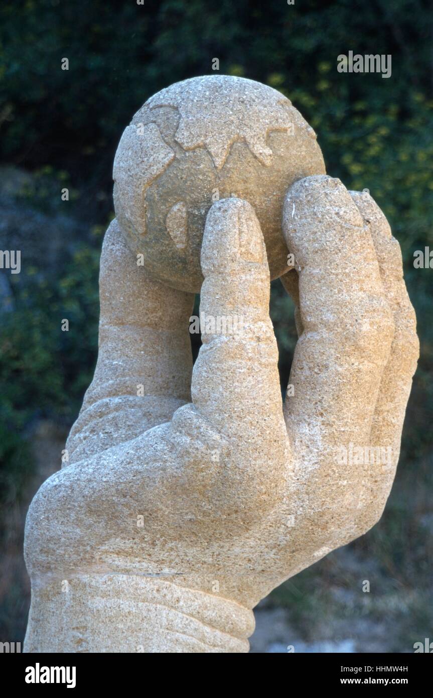 Sculpture: Hand keeps globe, Globalisation Stock Photo - Alamy