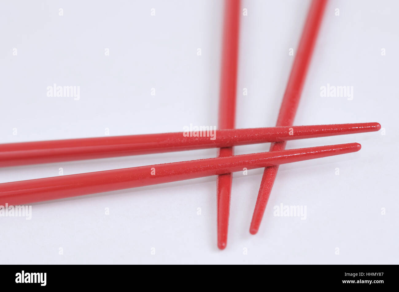Two pairs of red chopsticks on white paper Stock Photo - Alamy