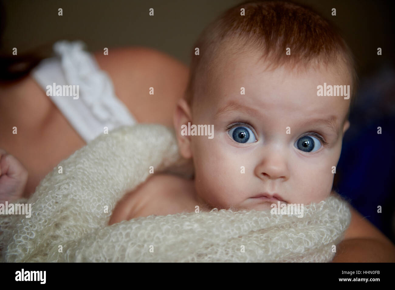 Little newborn baby with big eyes on a plain background Stock Photo - Alamy