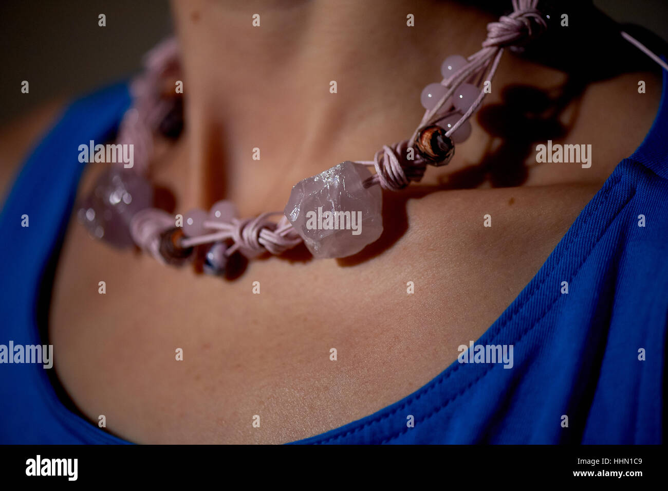 Decoration of large pink stones on a woman's neck. Movie light Stock ...
