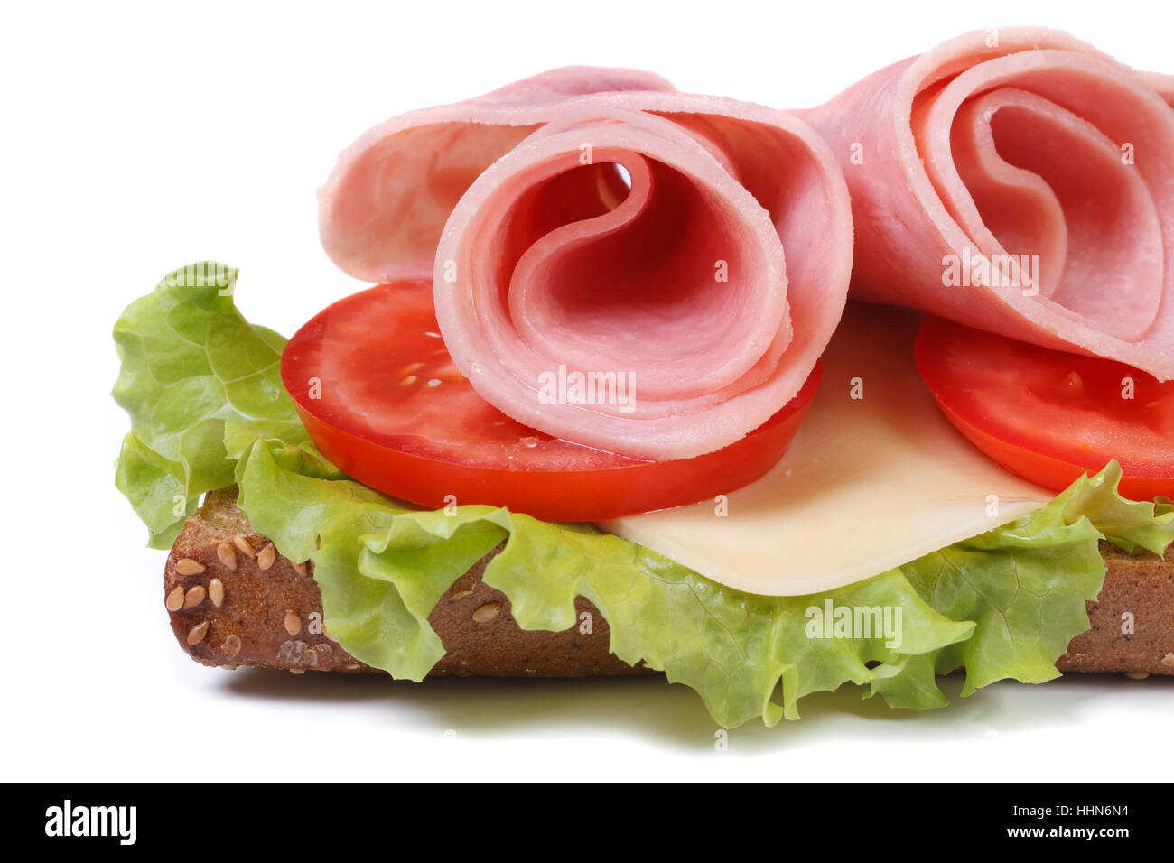 beautiful sandwich with ham and vegetables isolated on white background ...