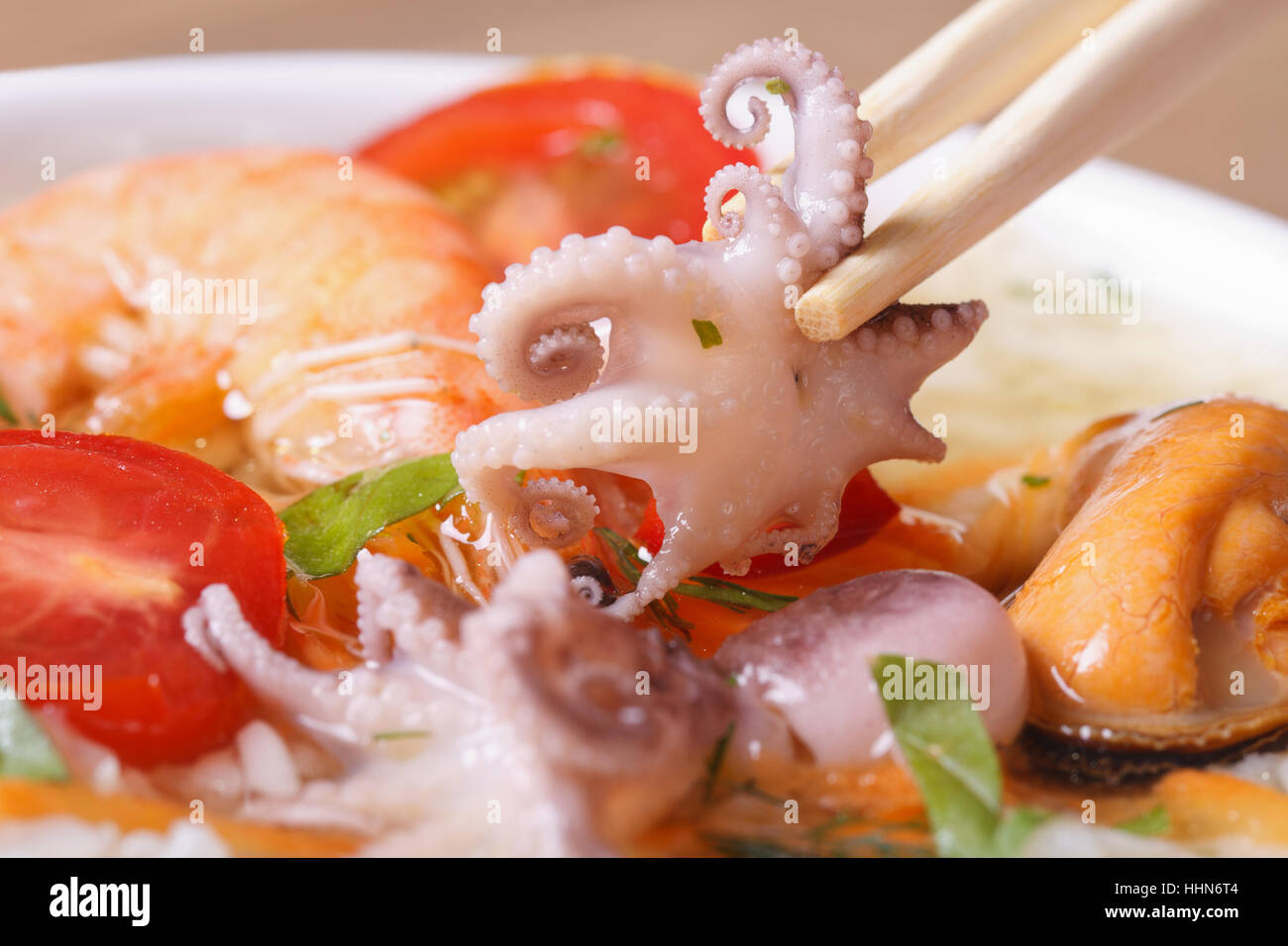 small an octopus keep chopsticks in soup from seafood. horizontal Stock ...