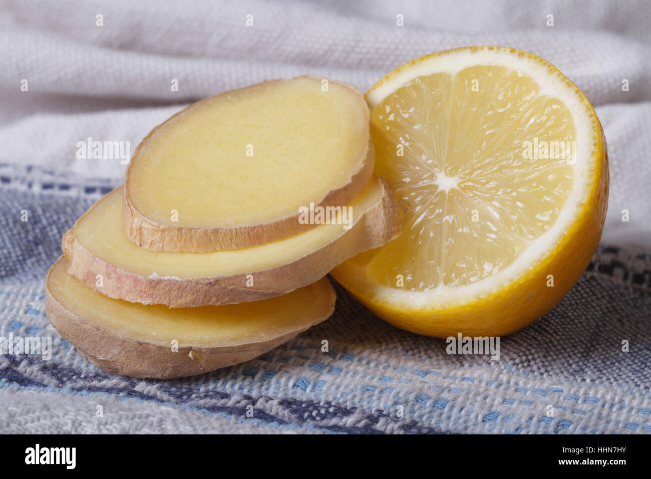 Sliced ginger root and half a lemon close up. horizontal Stock Photo ...