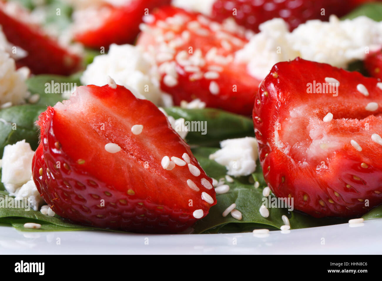 Strawberry closeup in vitamin salad with spinach. horizontal Stock ...