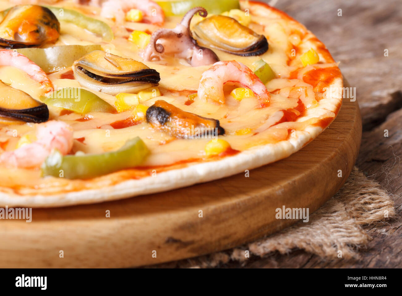 Detail of sea fruit pizza on the old table. horizontal. macro Stock ...