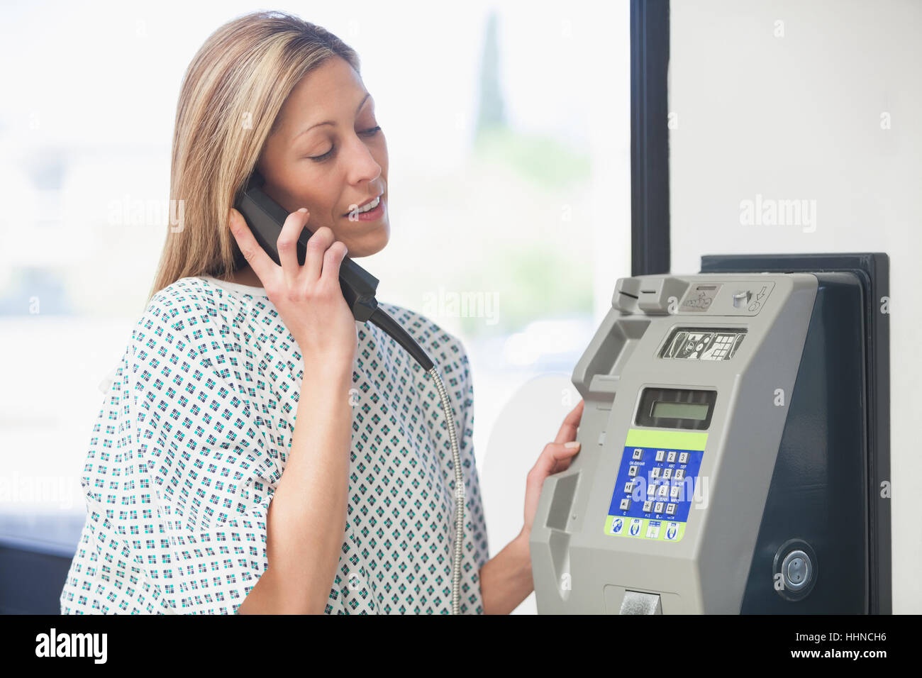 Female using payphone hi-res stock photography and images - Alamy