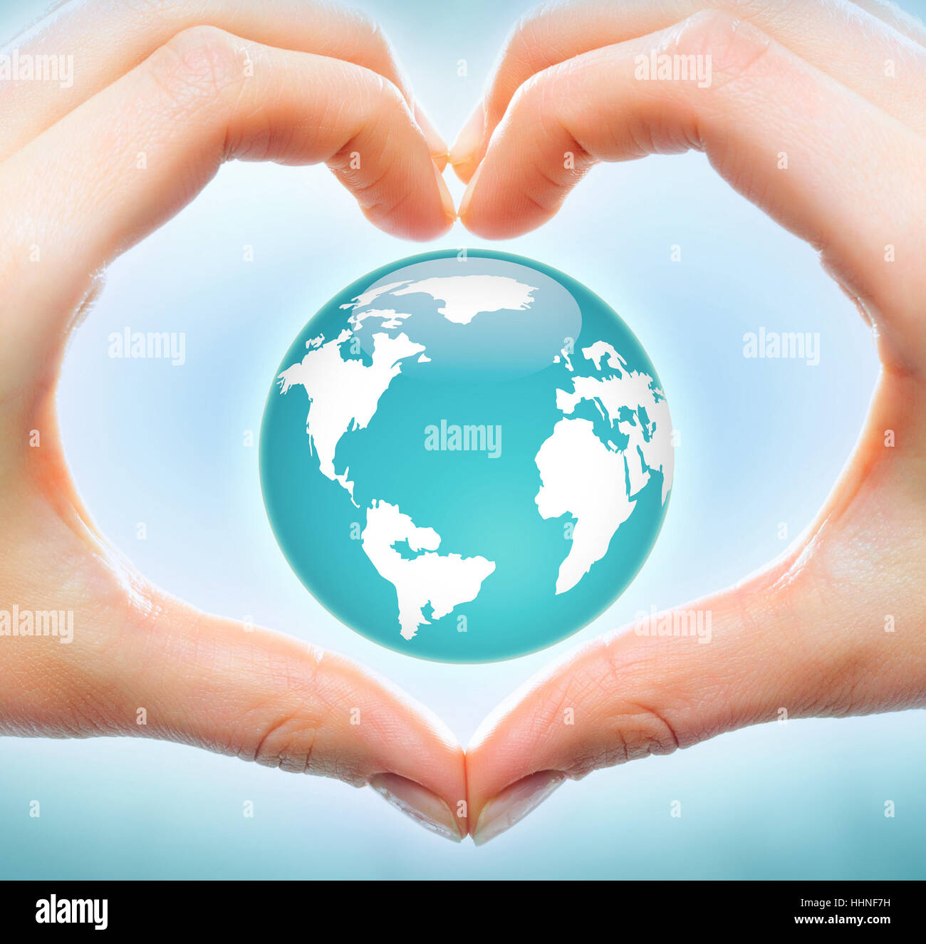Creative image of earth model inside heart made up of human hands Stock ...