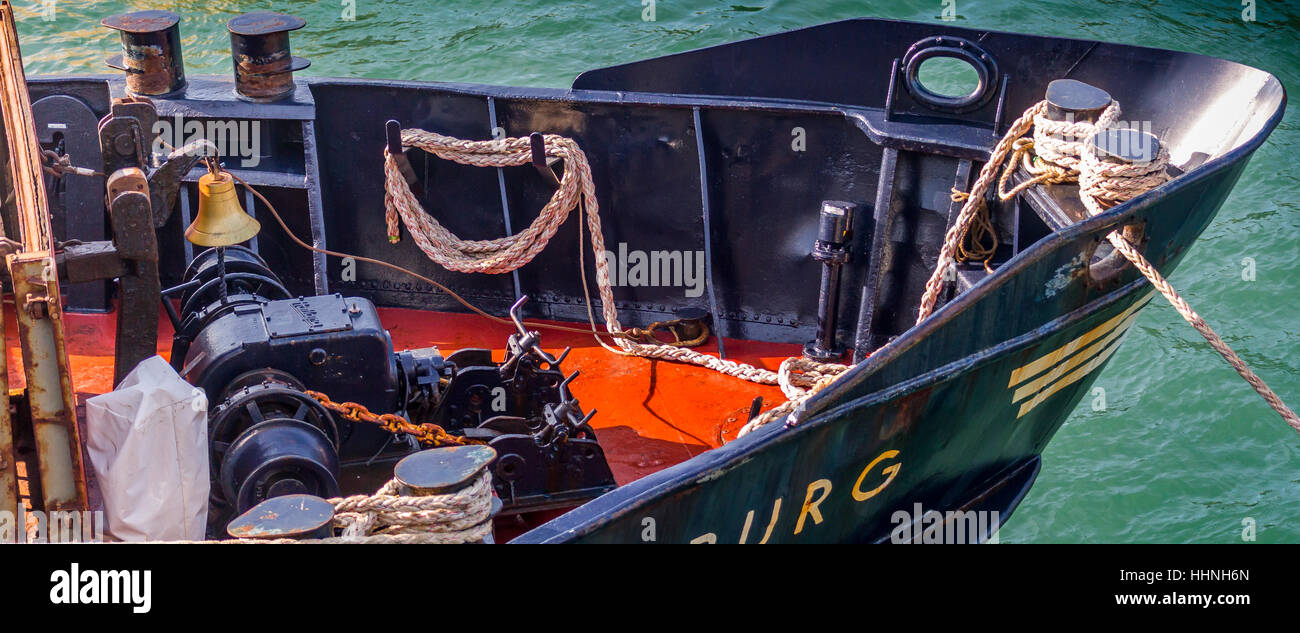 Boat deck with winch rope and bell Stock Photo - Alamy