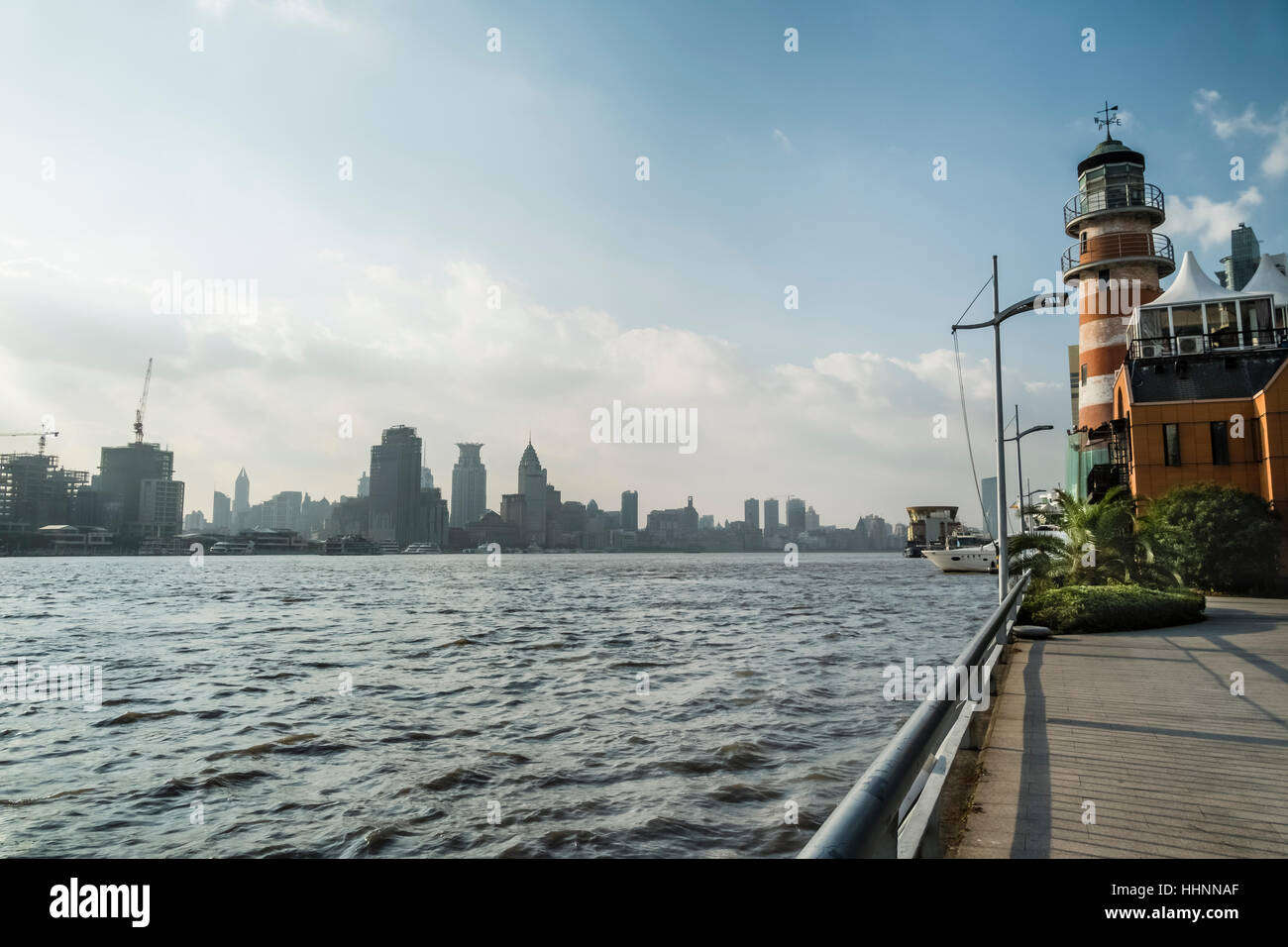 Boat Sailing Through River and Skyscrapers in the Distance Stock Photo ...