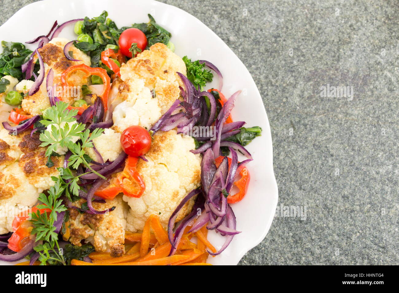 fried cauliflower and mixed vegetables on a stone surface Stock Photo ...