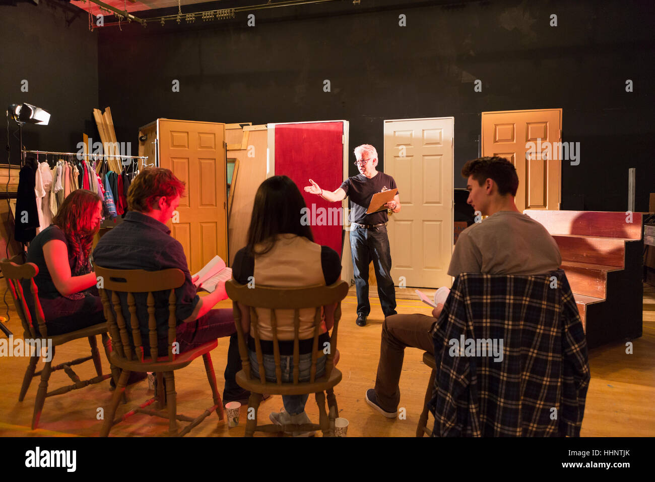 Teacher talking to students in theater class Stock Photo - Alamy