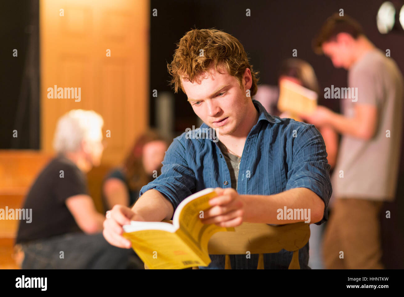 Caucasian teenage boy reading script in theater class Stock Photo - Alamy