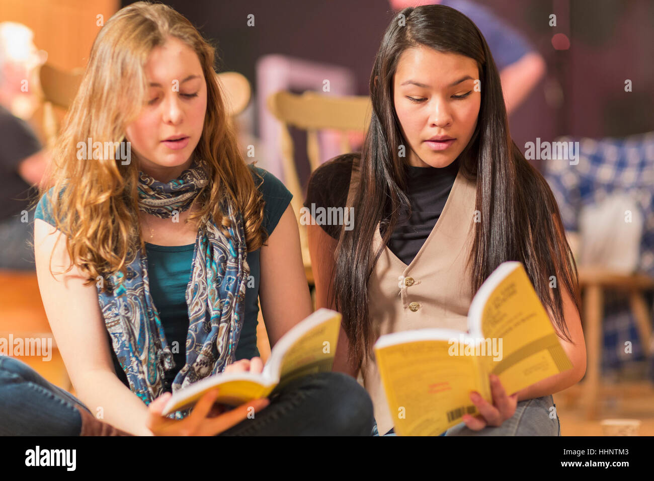 Teenage girls reading scripts in theater class Stock Photo - Alamy
