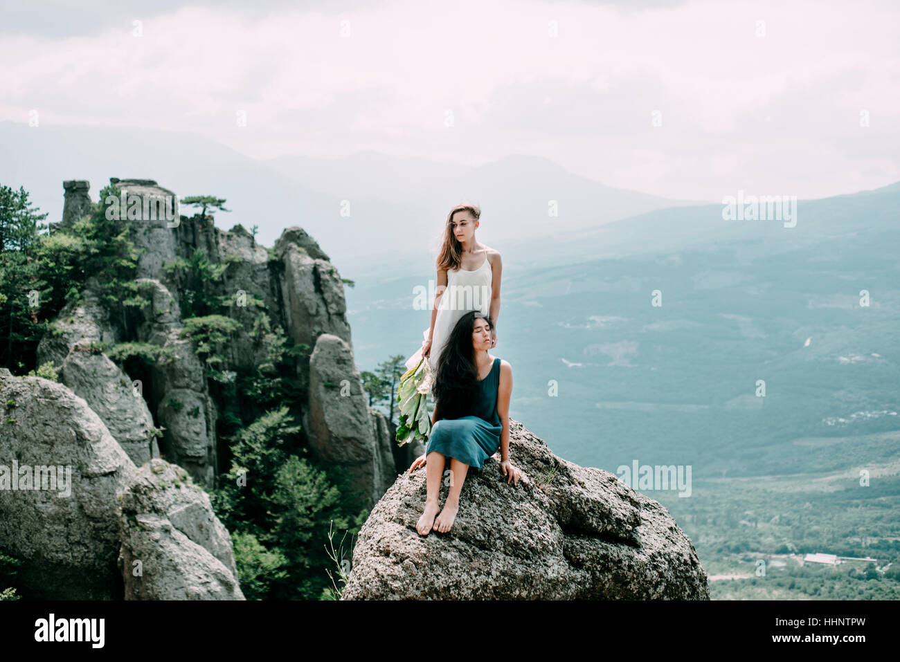 Women on rock overlooking landscape Stock Photo - Alamy