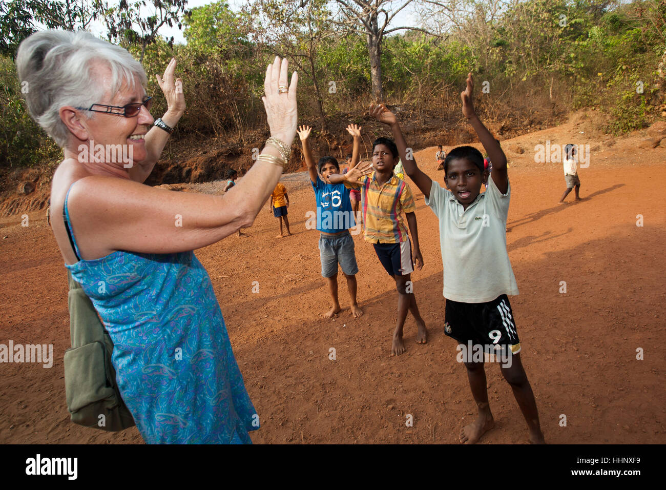 Visitor waves to young boys at El Shaddai Street Child Rescue home ...