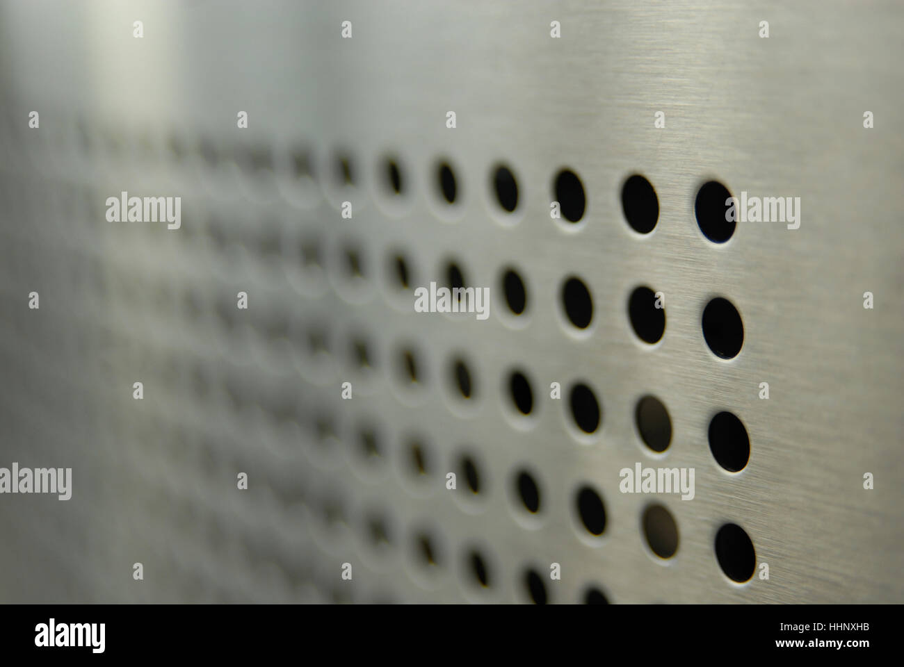 Aligned perforations on metallic surface Stock Photo - Alamy