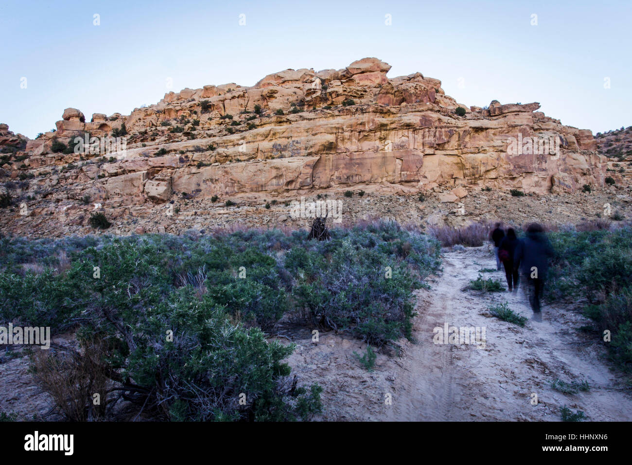 People walking on trail to rock formation Stock Photo - Alamy