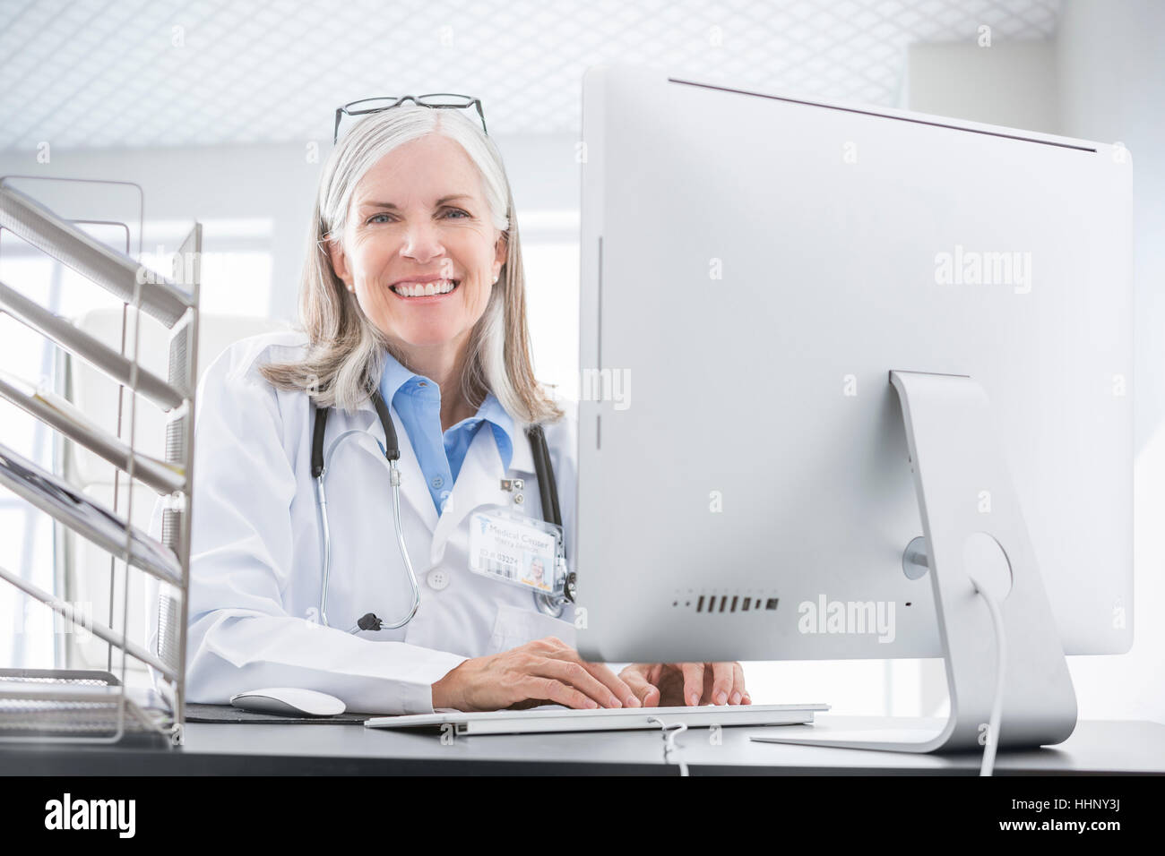 Smiling healthcare professional using hi-res stock photography and ...