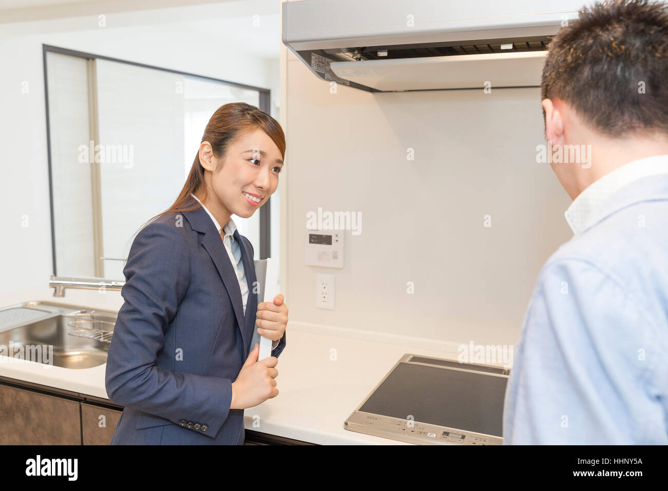 Real Estate Agent Showing Kitchen to Buyer Stock Photo - Alamy