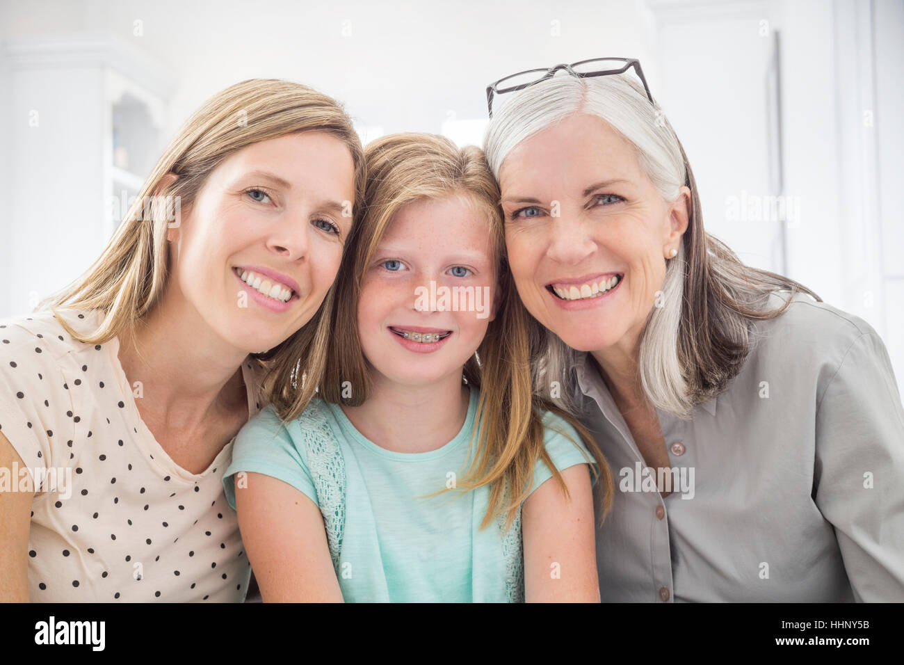 Portrait of women and girl smiling cheek to cheek Stock Photo - Alamy