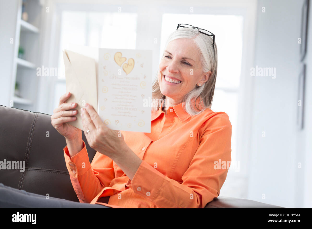 Caucasian women reading greeting card Stock Photo - Alamy
