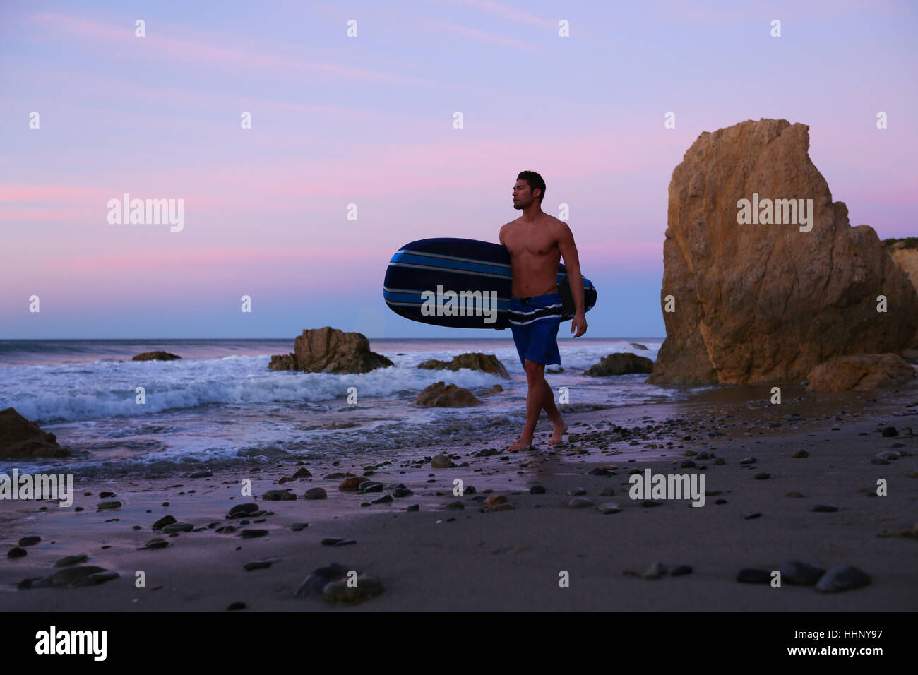 Man surfboard sunrise rock hi-res stock photography and images - Alamy