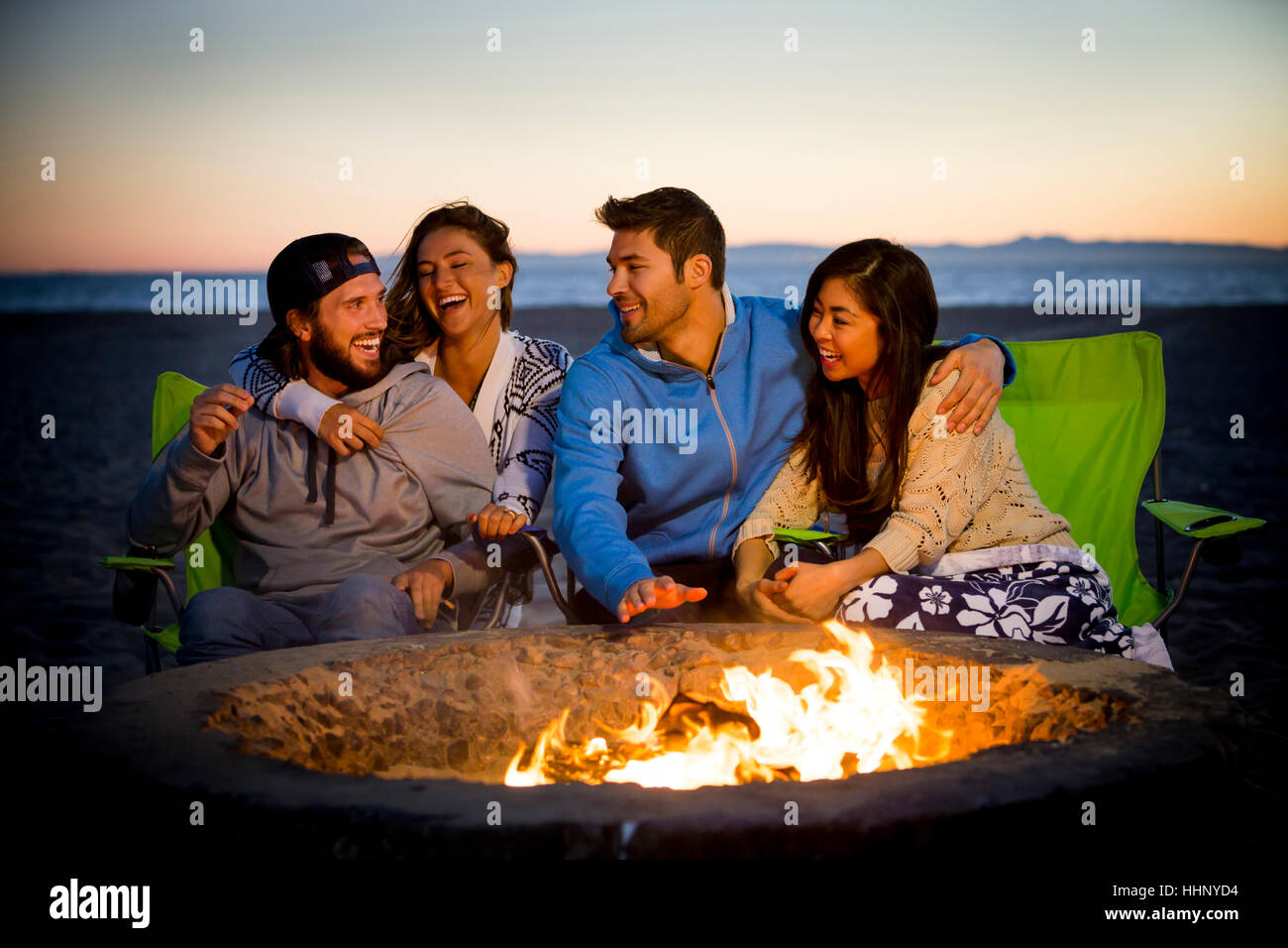 Couple sitting bonfire group hi-res stock photography and images - Alamy
