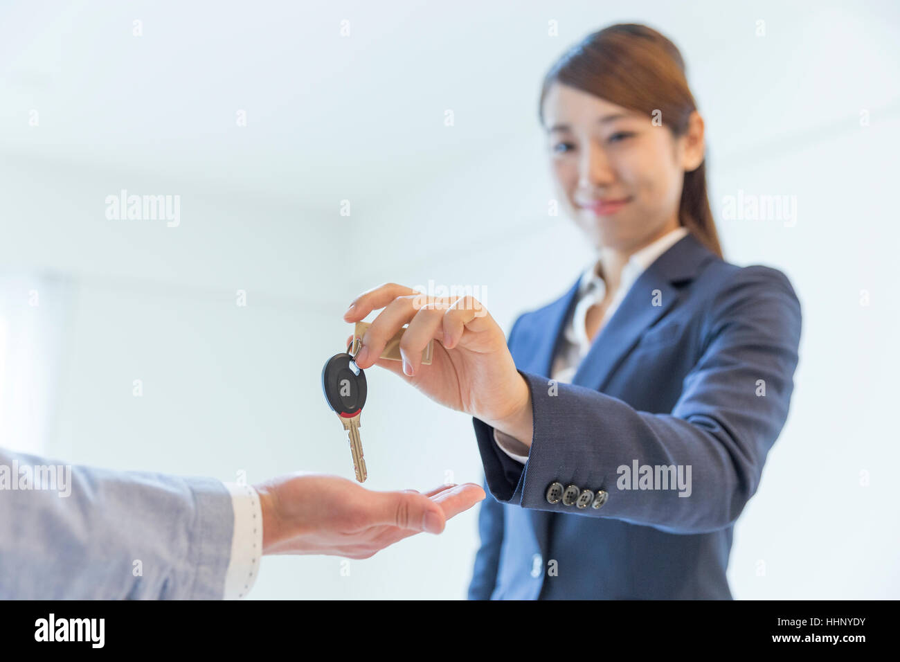 Woman Handing Key over to A Man Stock Photo - Alamy