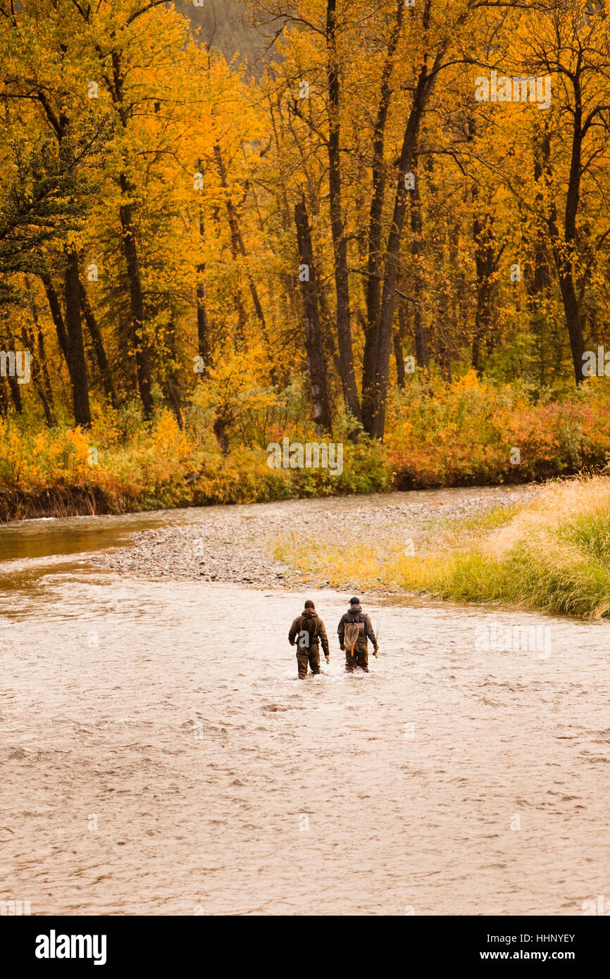 Caucasian men fishing in river Stock Photo - Alamy