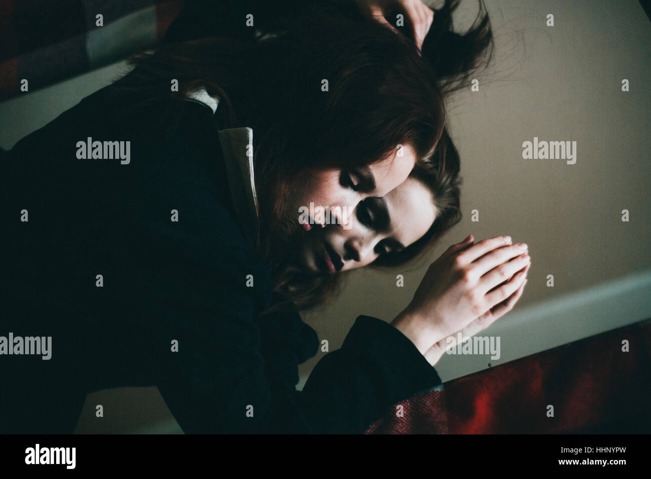 Caucasian woman laying on mirror Stock Photo - Alamy