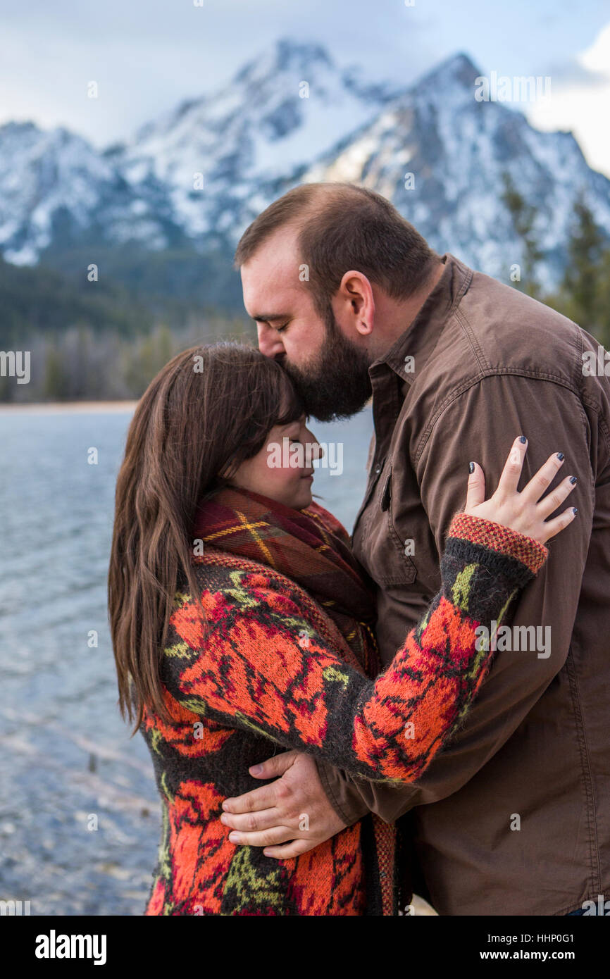 Caucasian couple kissing near river Stock Photo - Alamy